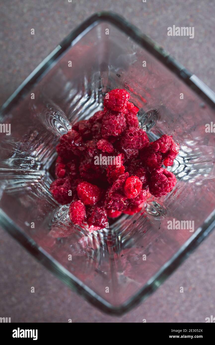 simple food ingredients concept, close-up of frozen raspberries with ...