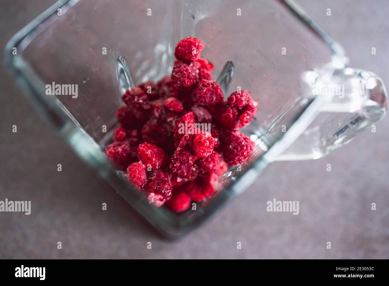 simple food ingredients concept, close-up of frozen raspberries with ...