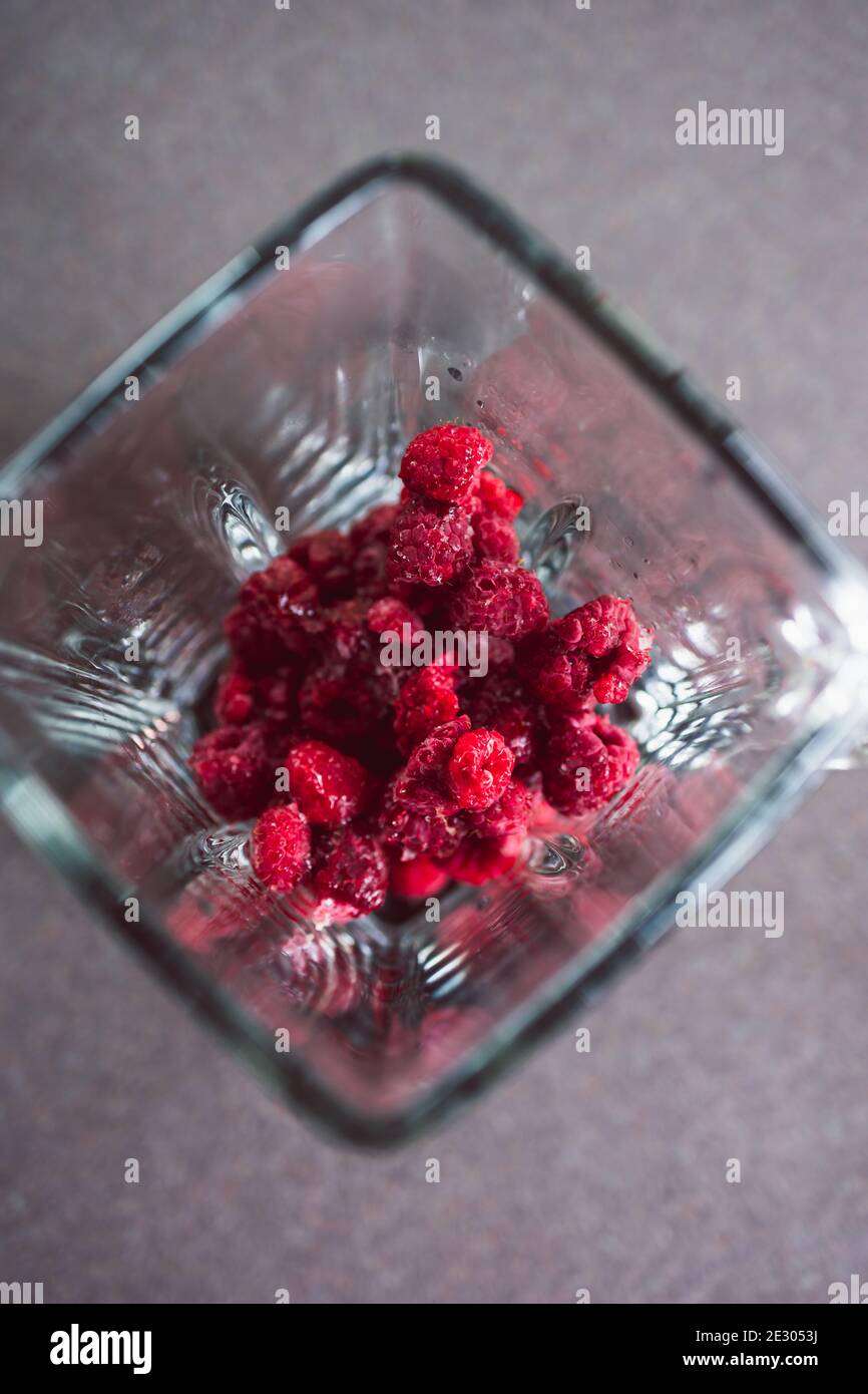 simple food ingredients concept, close-up of frozen raspberries with ...