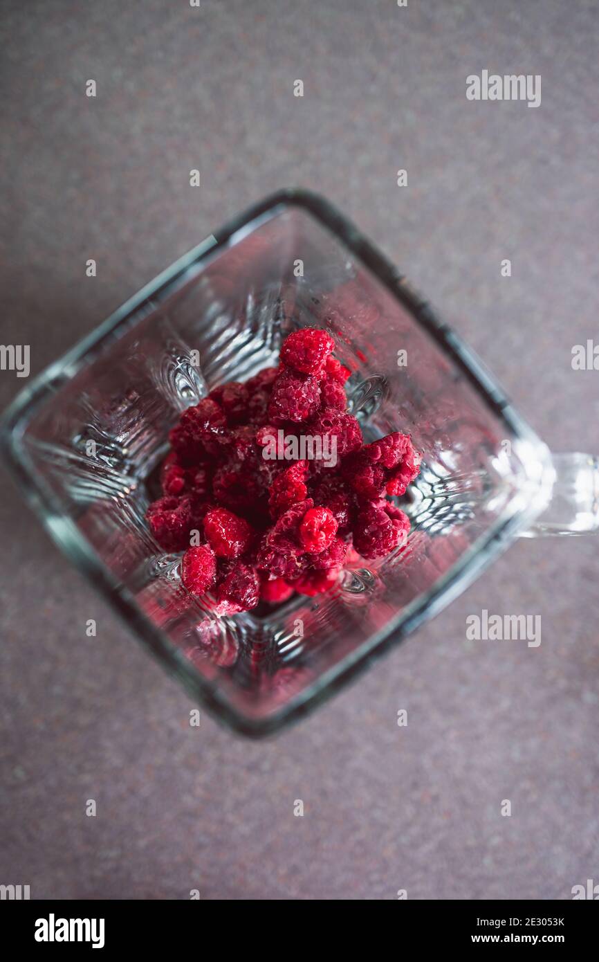 simple food ingredients concept, close-up of frozen raspberries with ...