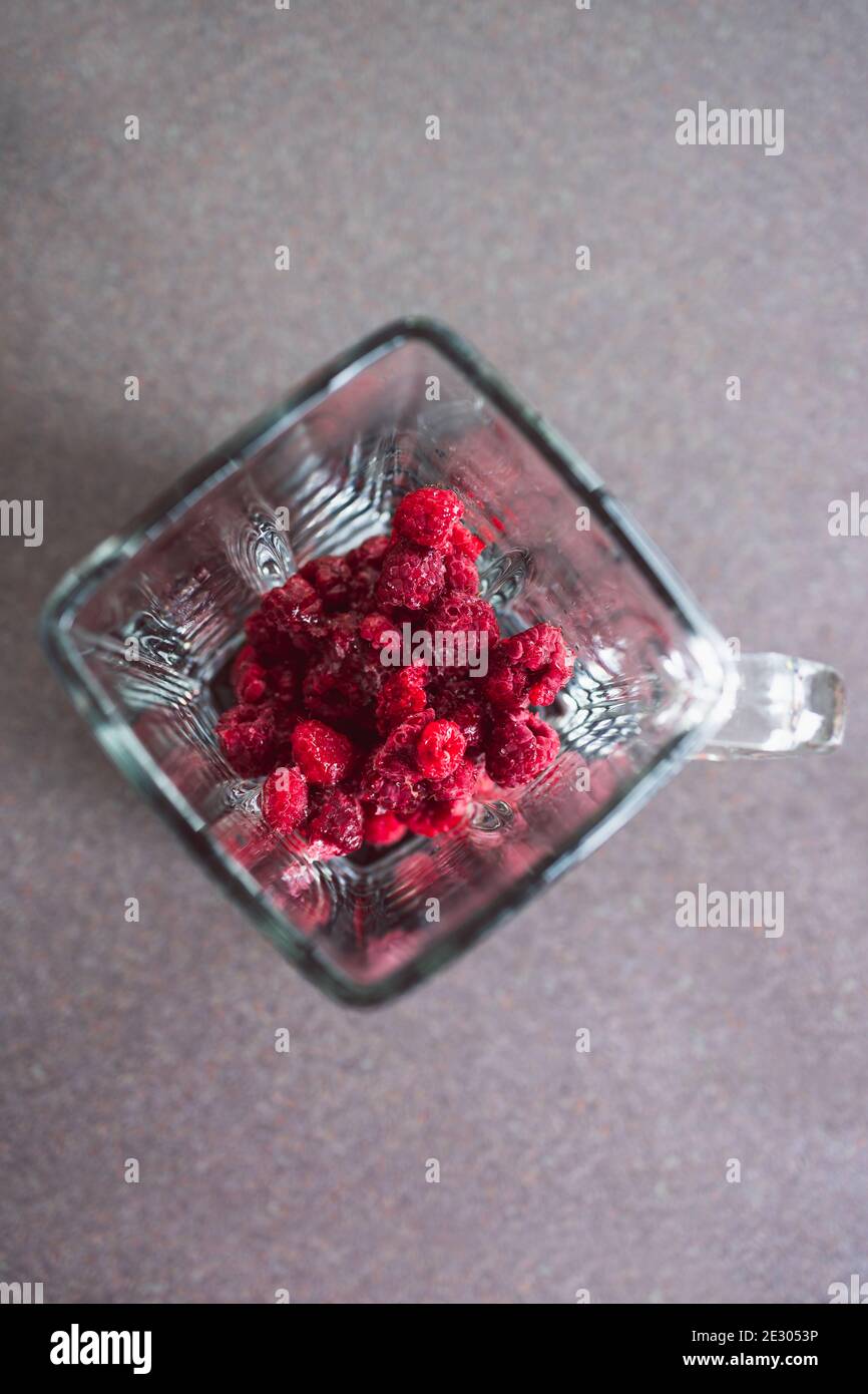simple food ingredients concept, close-up of frozen raspberries with ...