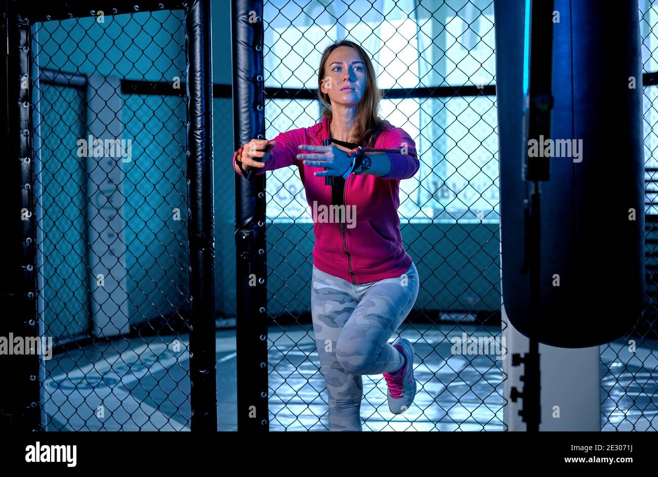 Aggressive girl standing in combat or defence position near the ...