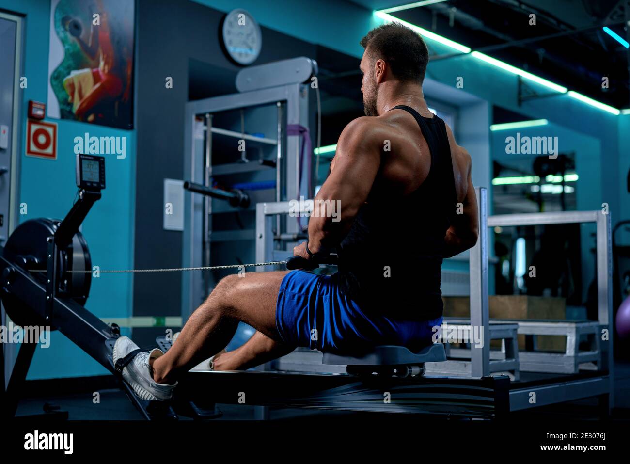 Side view portrait of a man workout on a fitness machine at gym Stock ...