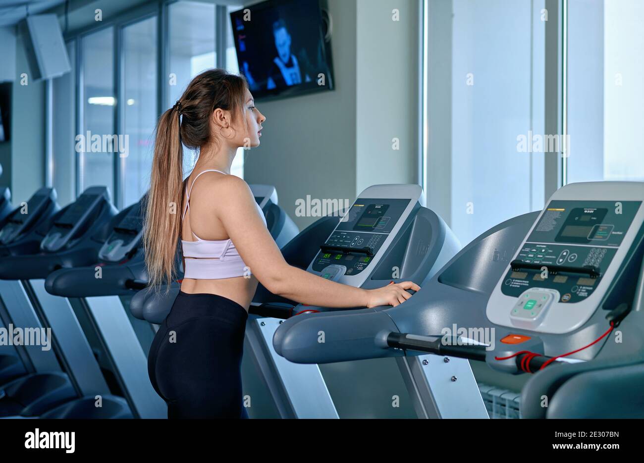 group of young people running on treadmills in modern sport gym Stock ...