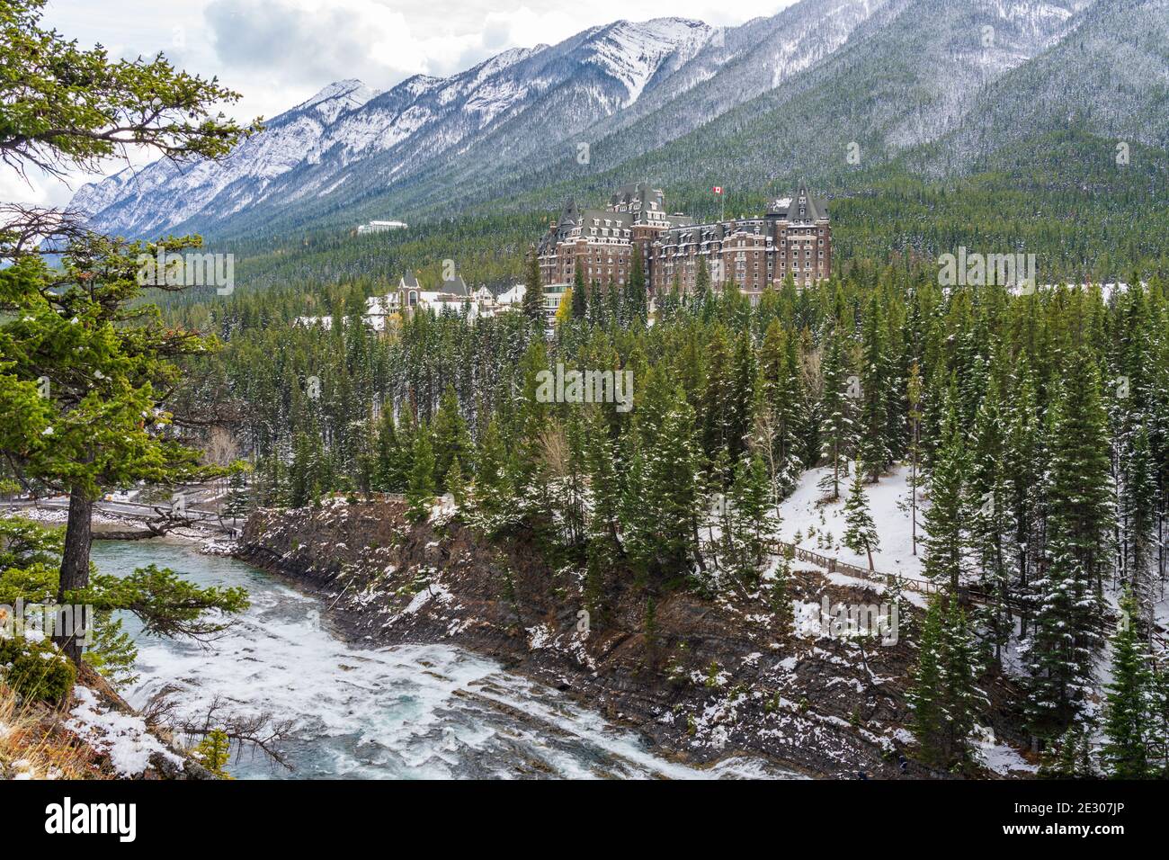 Fairmont Banff Springs and Bow River Falls in snowy autumn sunny day ...
