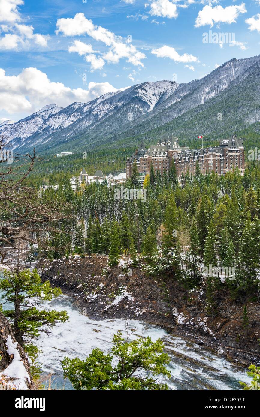 Fairmont Banff Springs and Bow River Falls in snowy autumn sunny day ...