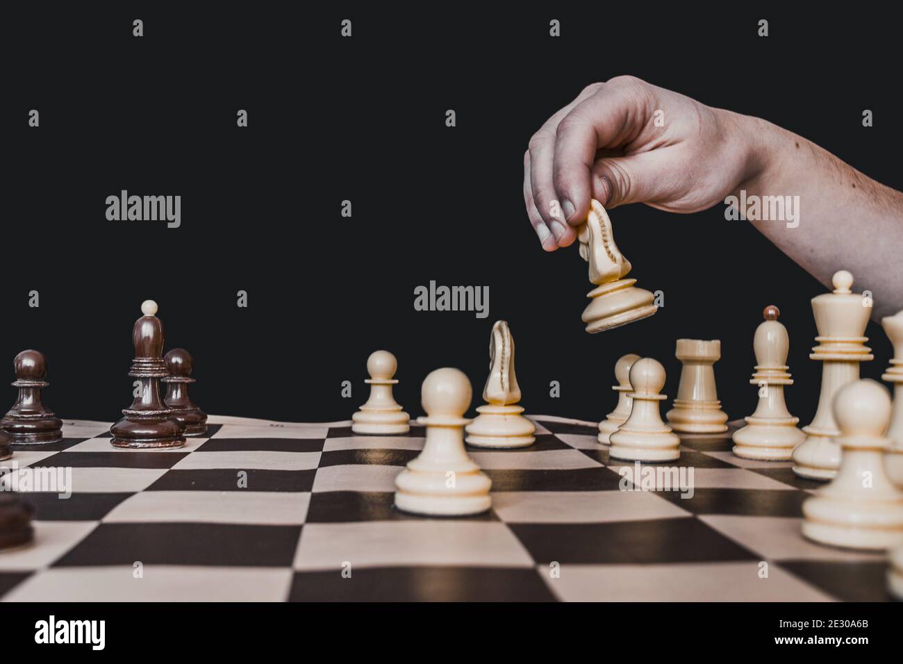 Hand playing chess with white pieces Stock Photo - Alamy