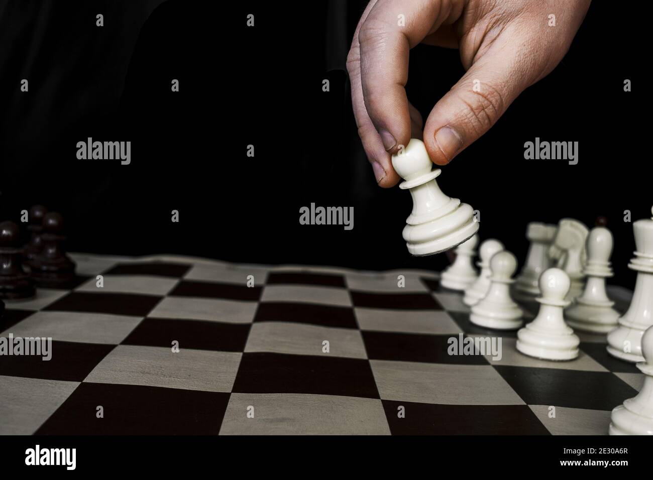 Hand playing chess with white pieces Stock Photo - Alamy