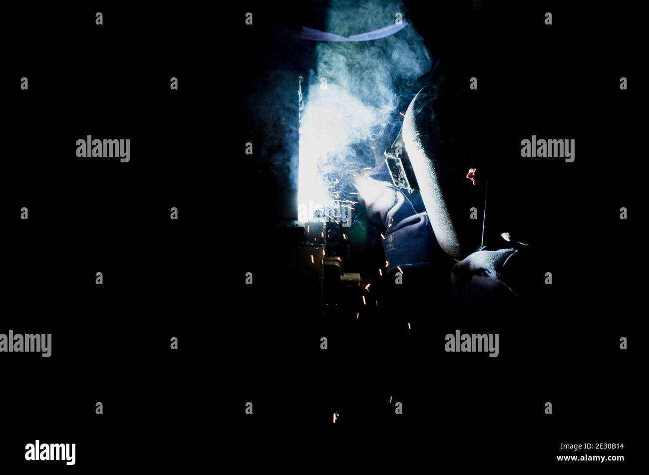 Steel Welder doing weld on keel block fabrication in a workshop with a ...