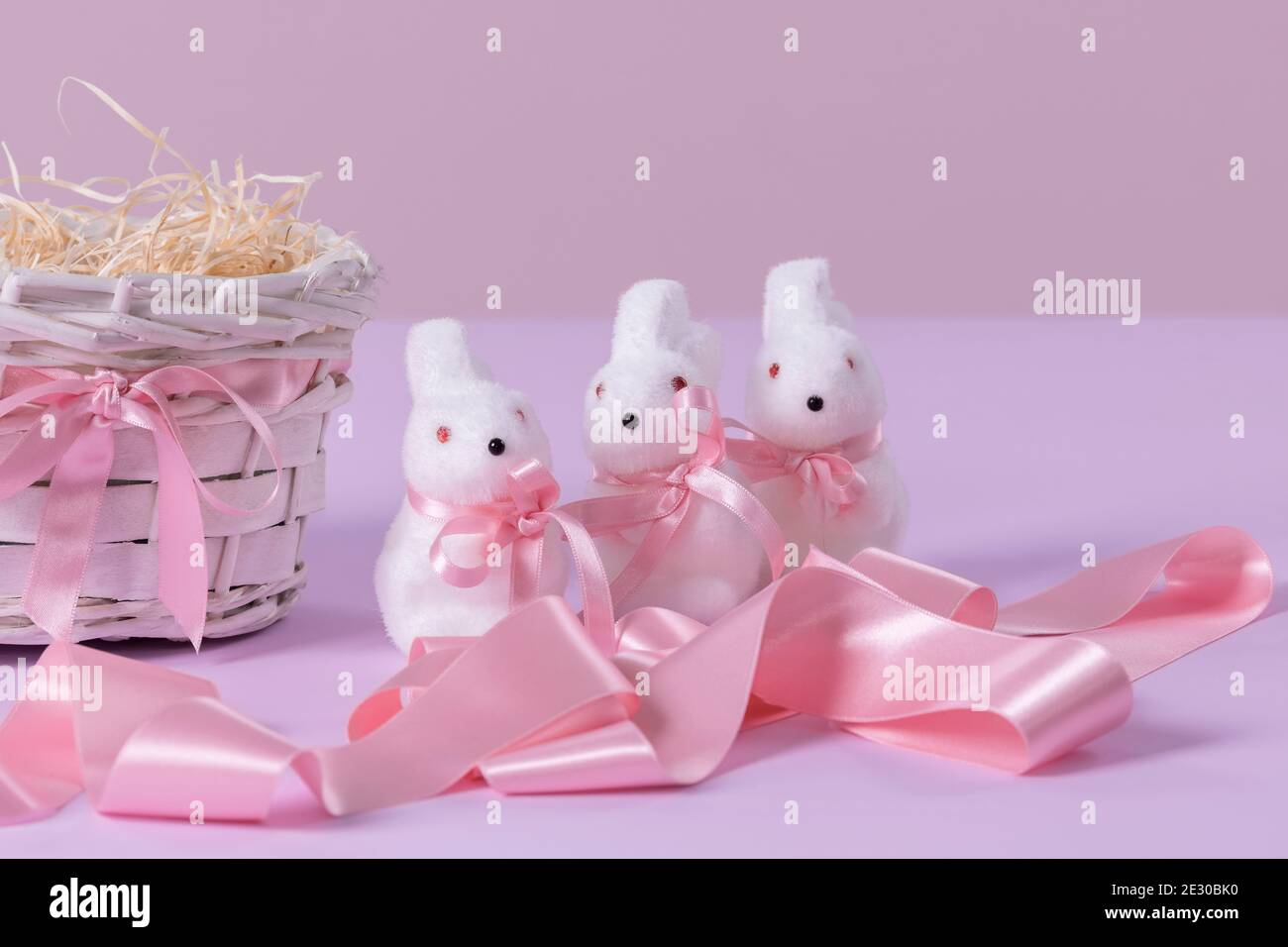 Cute decorated bunny figurines with pink ribbon Stock Photo - Alamy