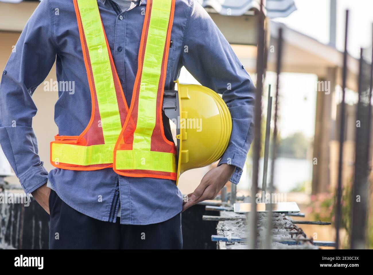 Engineer hold yellow hard hat helmet on site building construction ...