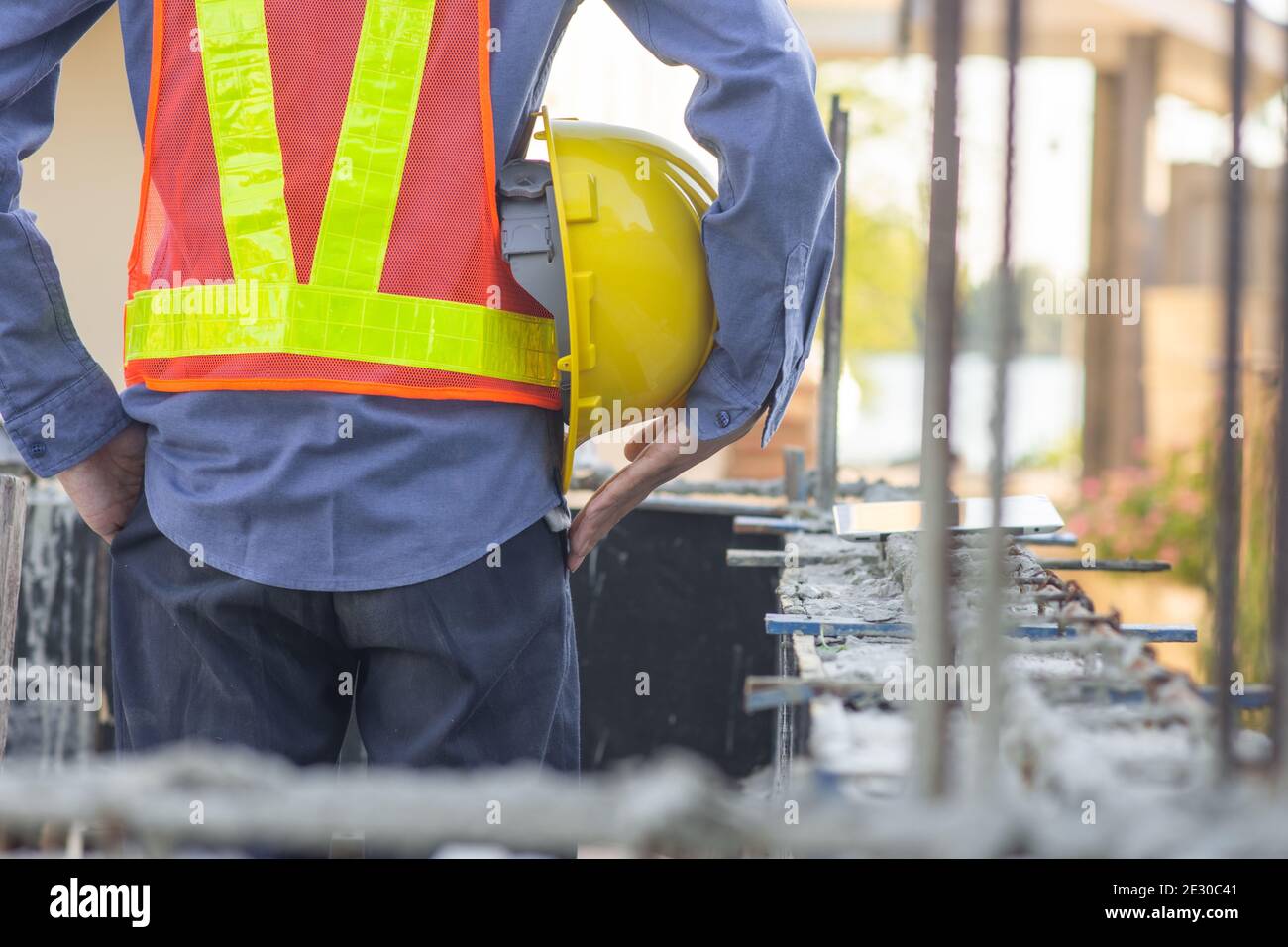 Engineer hold yellow hard hat helmet on site building construction ...