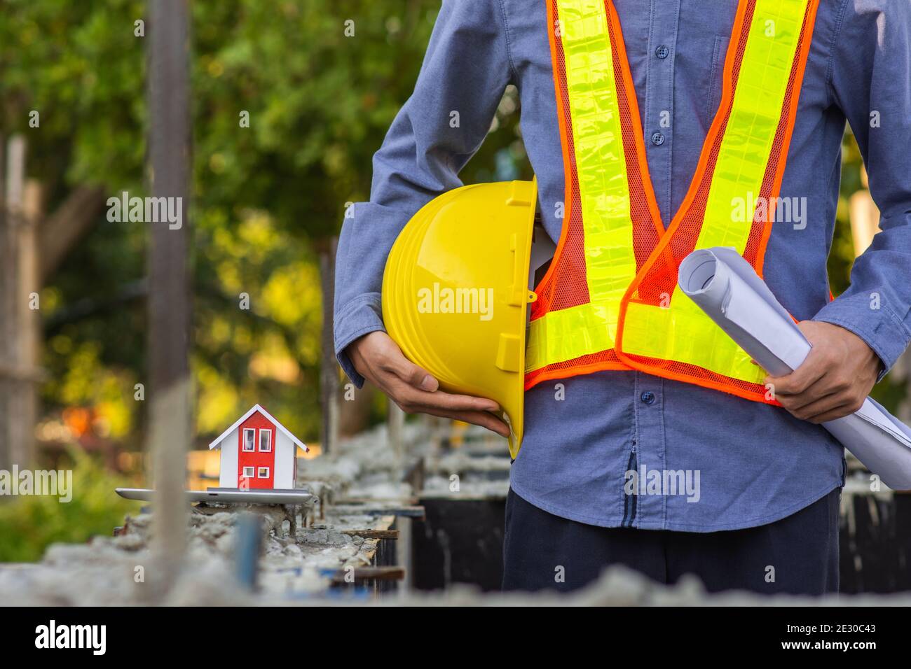 Engineer hold yellow hard hat helmet on site building construction ...
