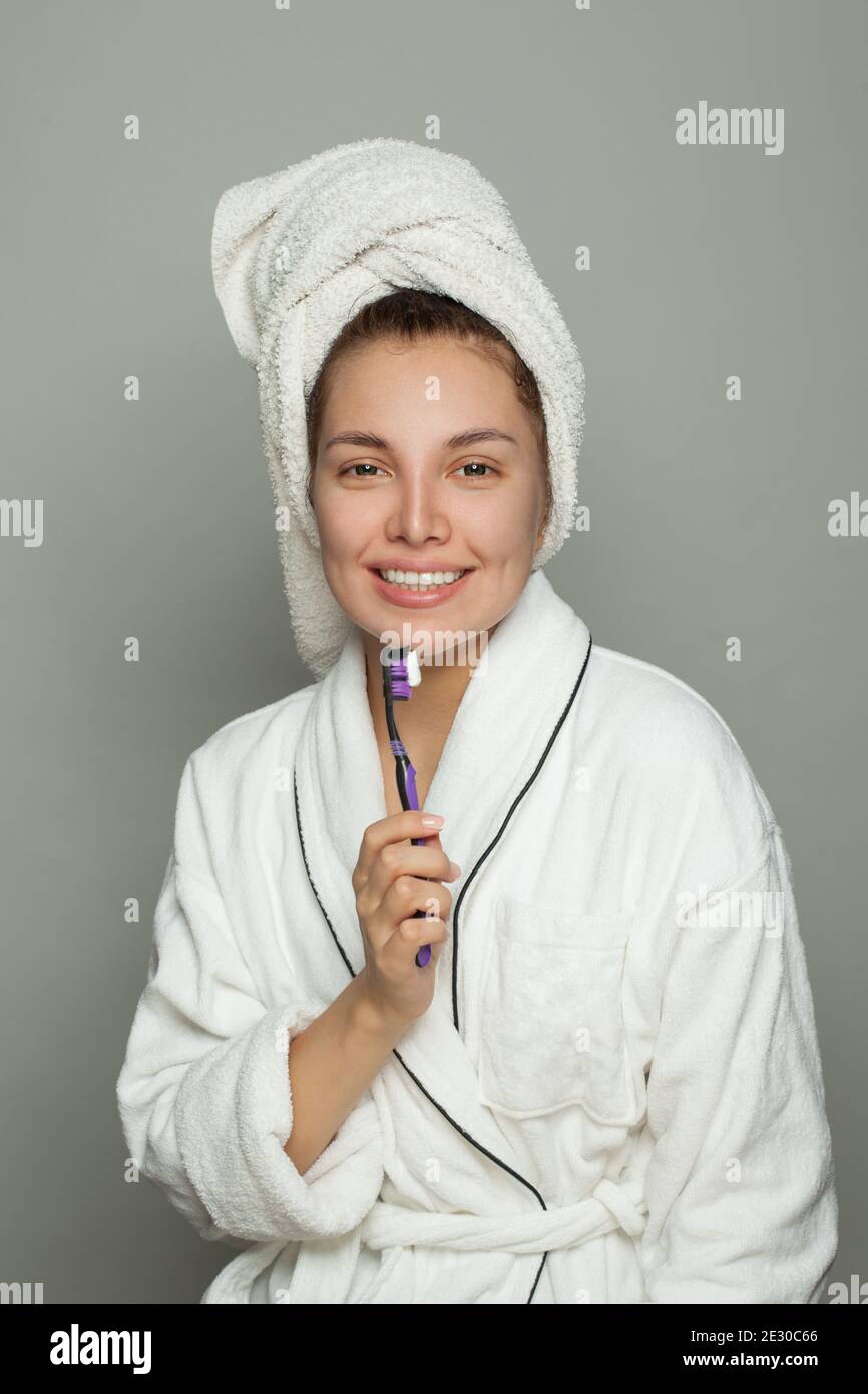 Happy young woman with white teeth, toothbrush and toothpaste on white ...