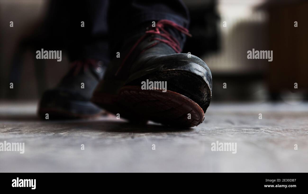 A leather boot with wide open sole at tip, in close up low angle shot ...