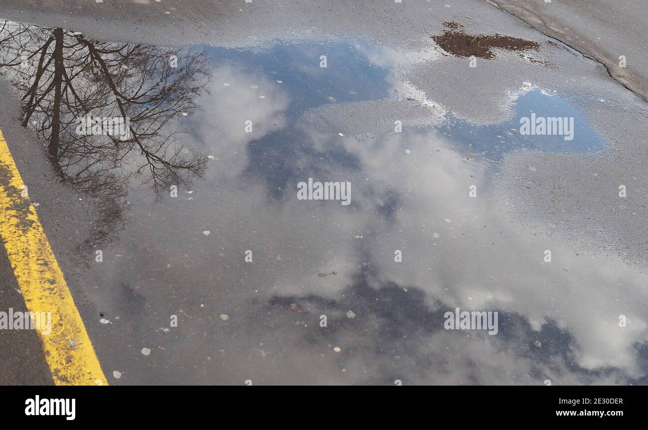 Reflection of sun and clouds in a puddle hi-res stock photography and ...