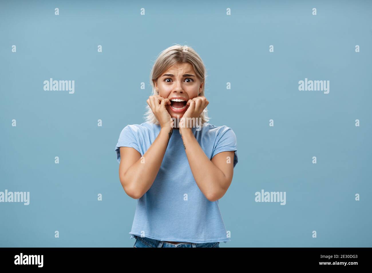 Indoor shot of shocked troubled girlfriend hearing mom returned home ...