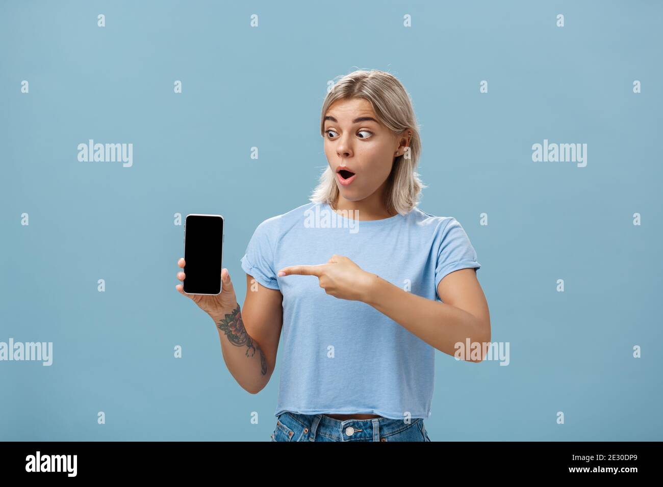 Girl being amazed with cool new smartphone received on birthday ...