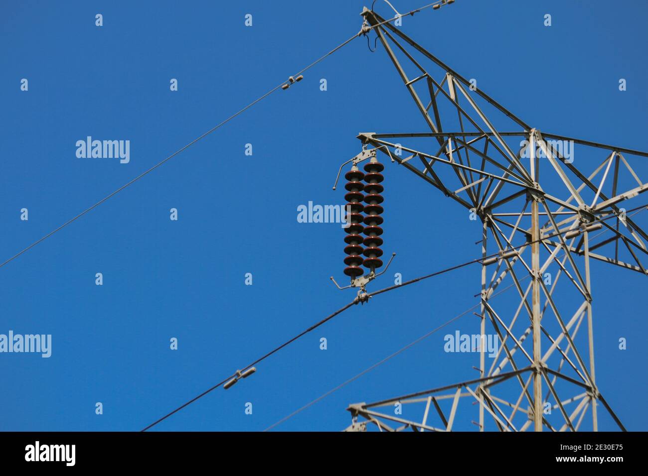 Close up of electricity tower transmission pylon with blue sky ...