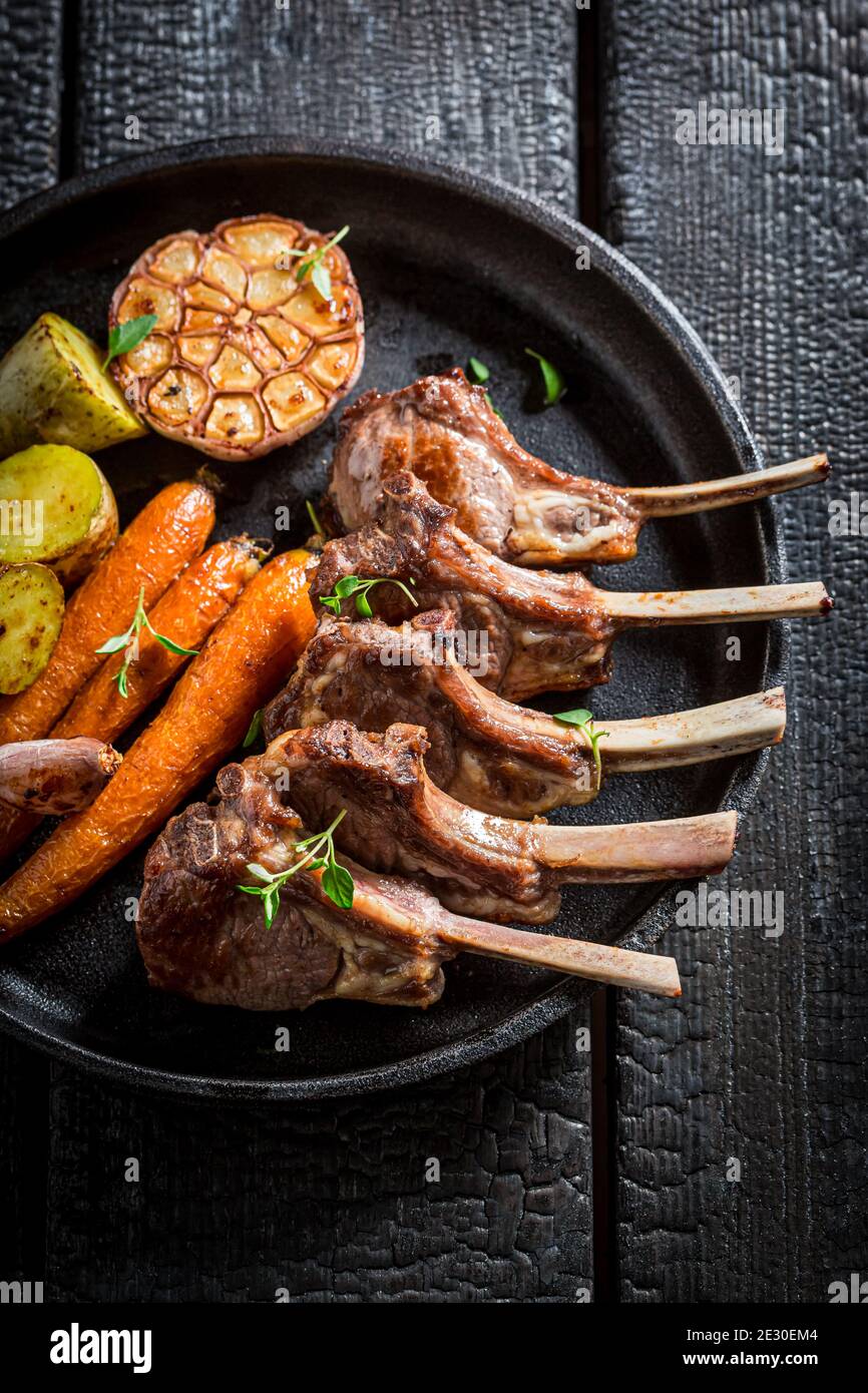 Top view of roasted ribs of lamb with vegetables and garlic Stock Photo ...