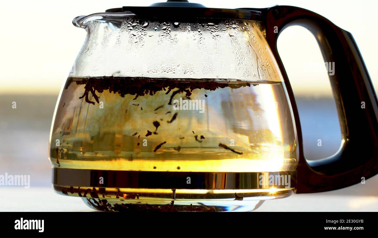 Toss a Pinch of Dry Black Tea Leaves into the Teapot. Close-up Glass ...