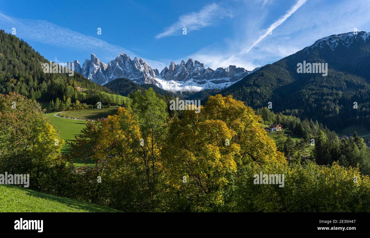 The Geisler mountains in the Dolomites in autumn with blue sky and ...