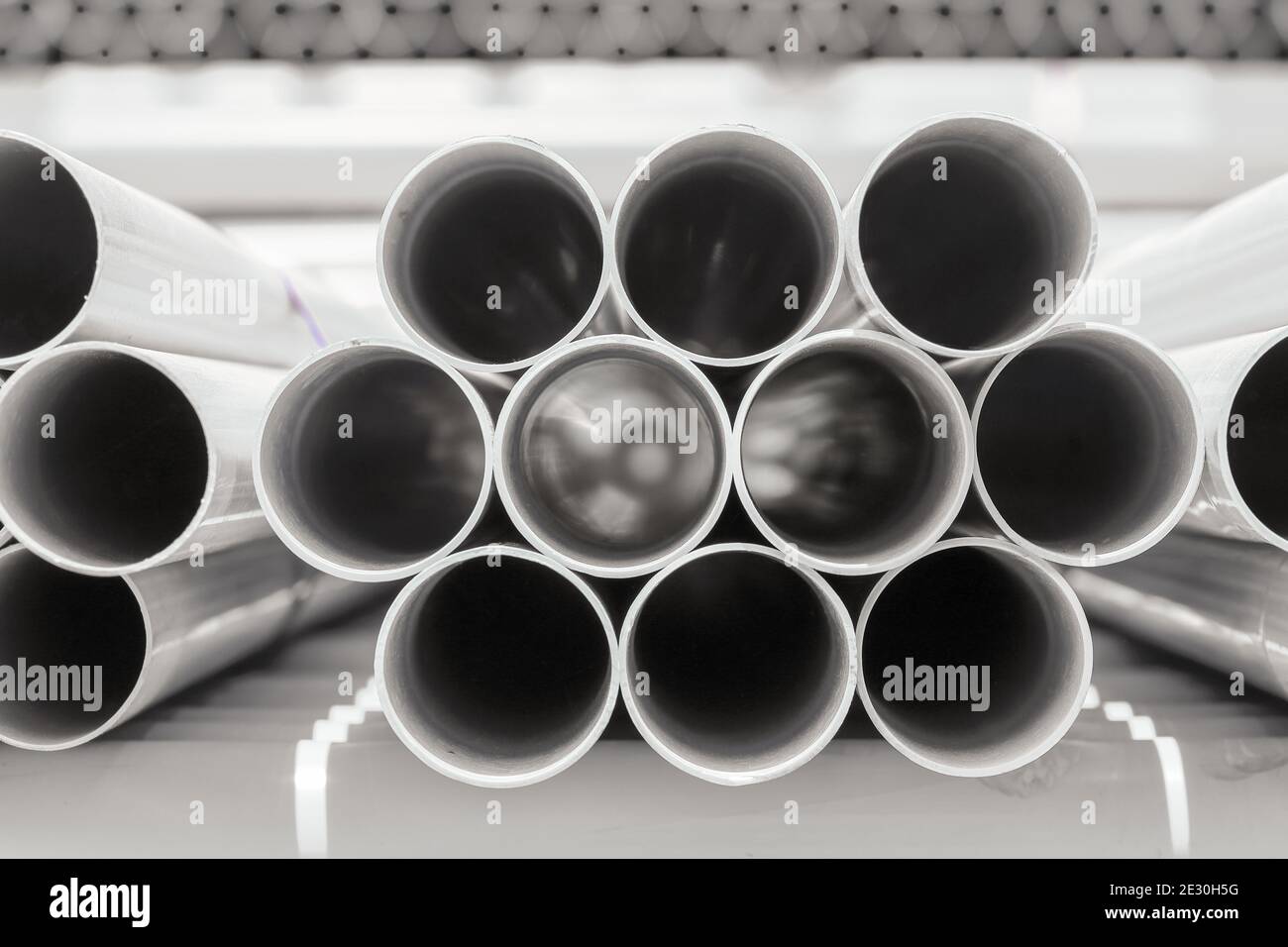 PVC pipes stacked in warehouse Stock Photo - Alamy
