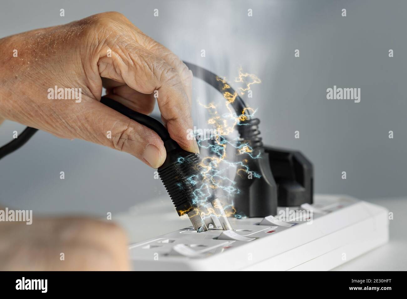 Hand inserting electrical plug hi-res stock photography and images - Alamy