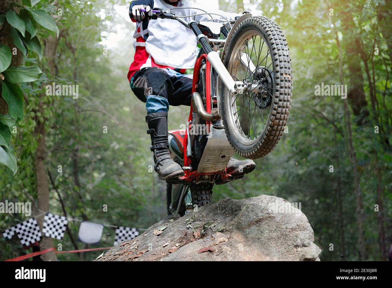 Trials motorcycle is jumping over rocks Stock Photo - Alamy