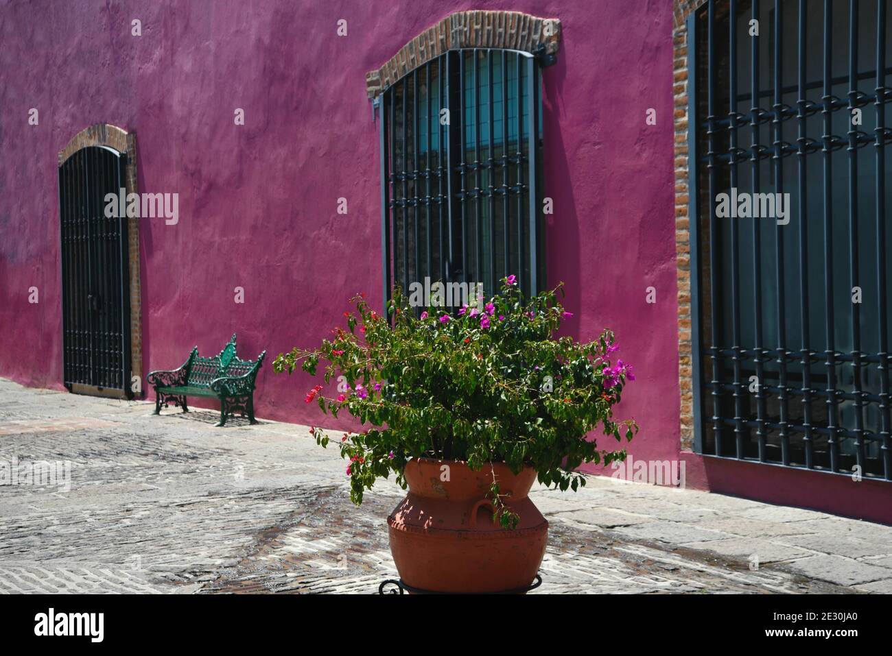 Old Colonial building with a plum stucco wall, handcrafted iron grilles ...