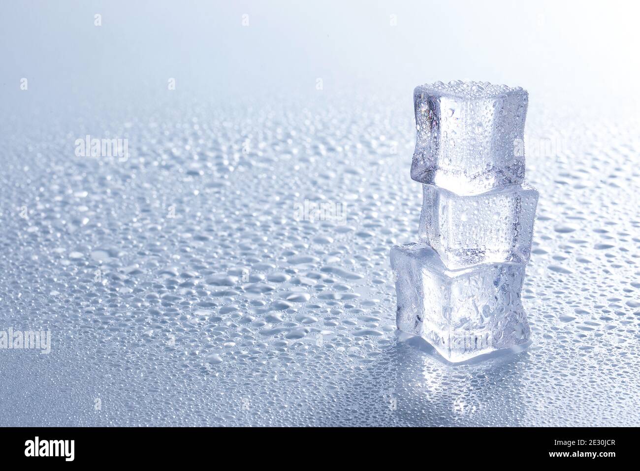 Selective focus shot of melting ice cubes on a wet surface Stock Photo ...