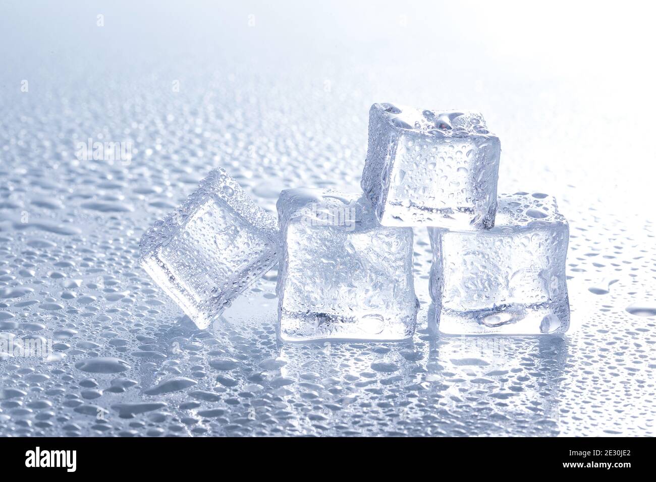 Selective focus shot of melting ice cubes on a wet surface Stock Photo ...