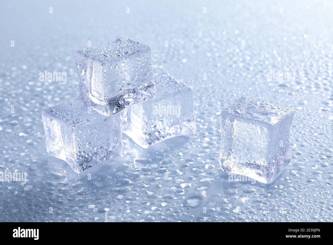 Selective focus shot of melting ice cubes on a wet surface Stock Photo ...