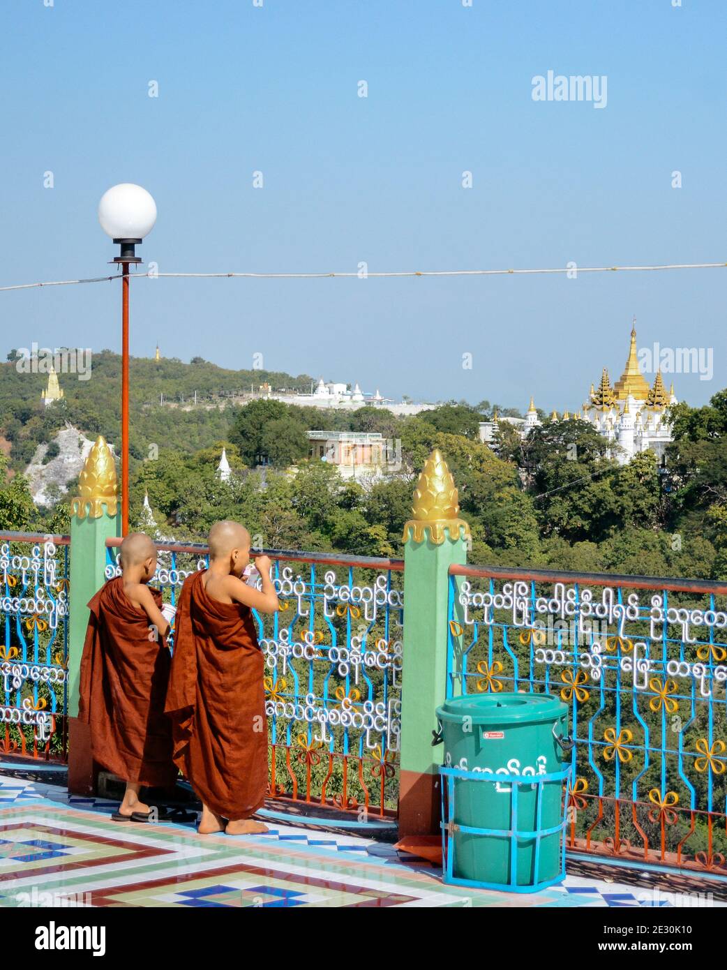 Sagaing, Myanmar - Two boy monks eating ice cream and looking at ...