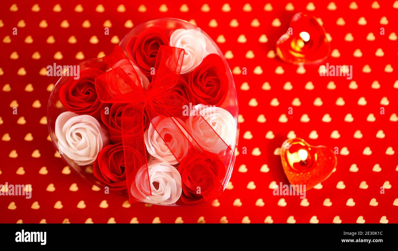 Valentines day gift on a red background. A lot of red and white roses ...