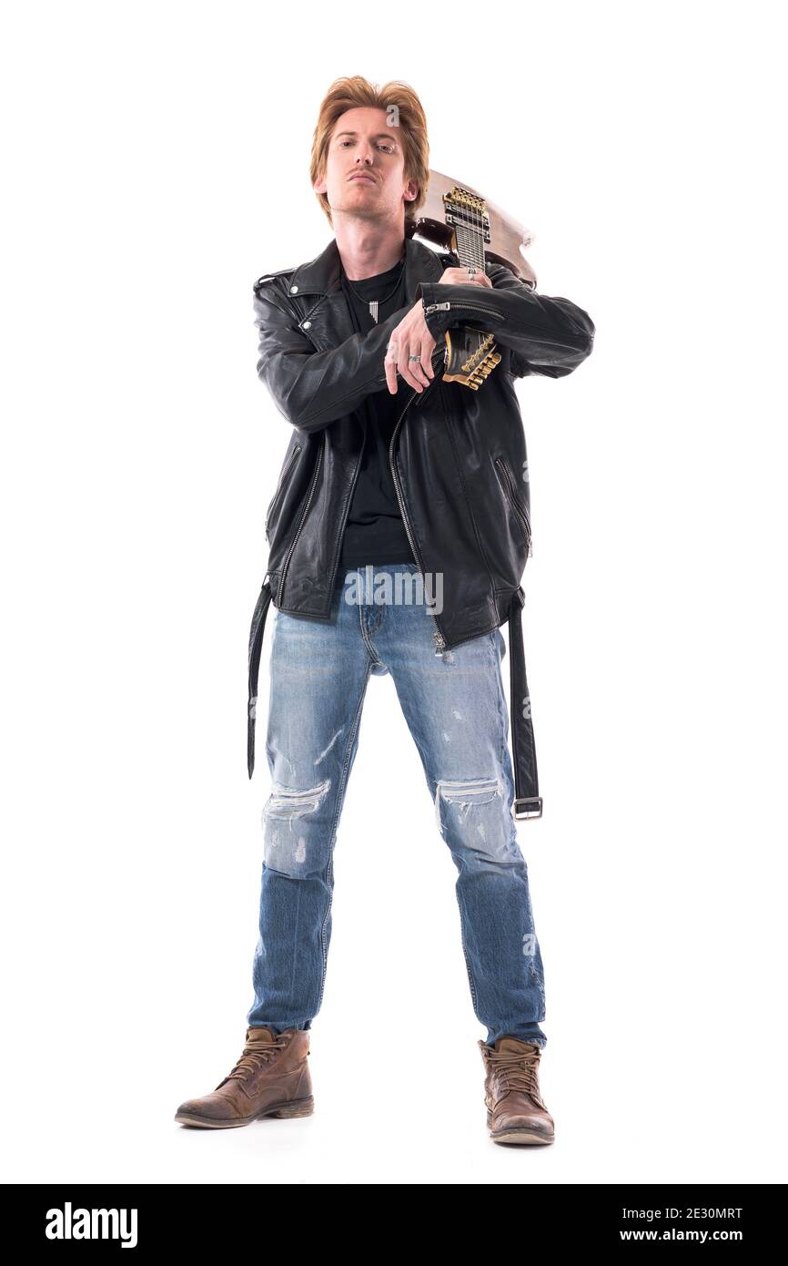 Cocky attitude macho rocker in leather jacket carrying electric guitar ...