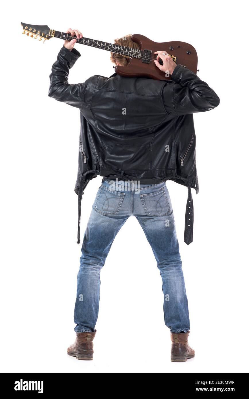 Back view of male skilled rock guitarist playing electric guitar on his ...