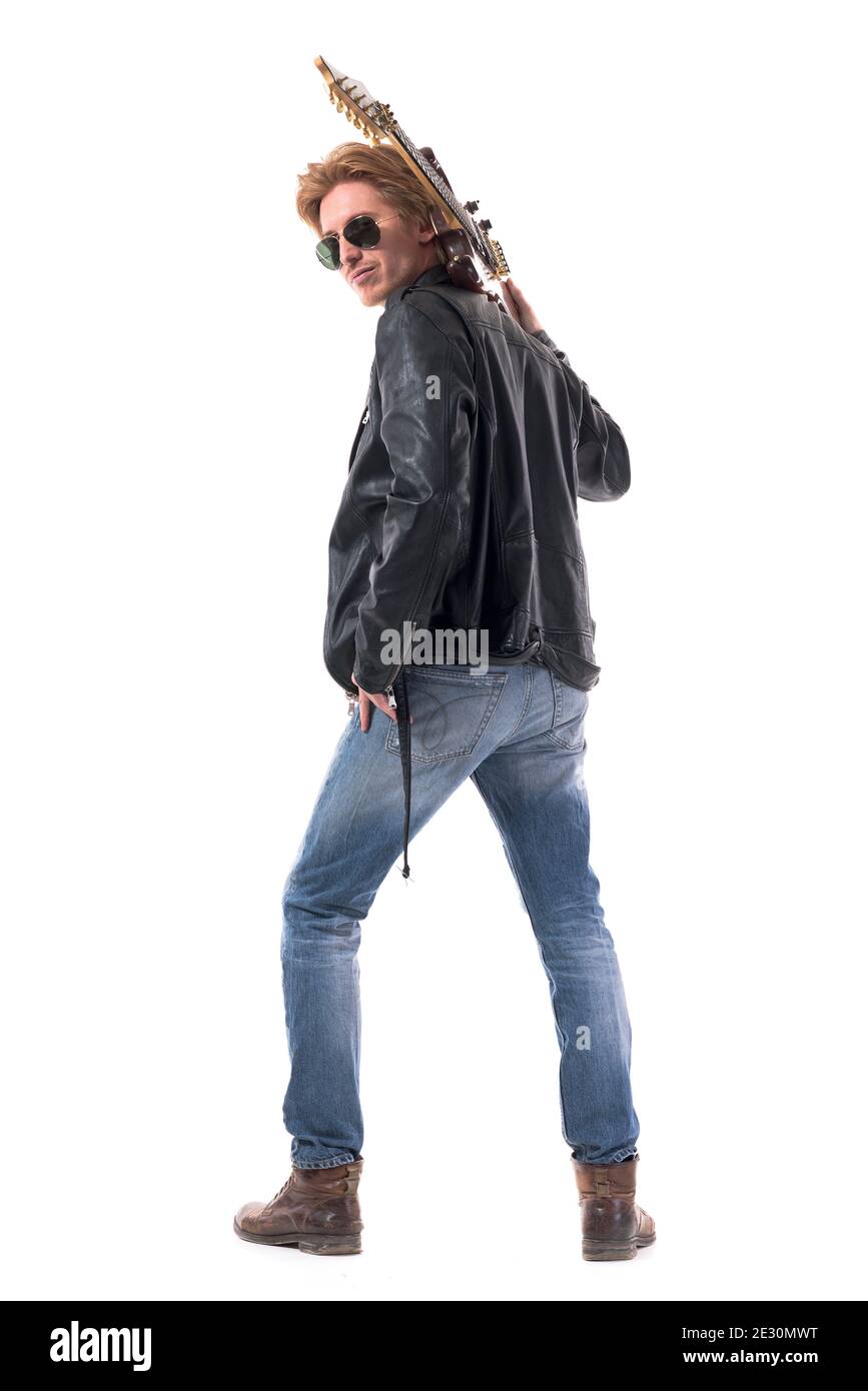 Back view of cool macho rock music guitarist turning at camera posing ...
