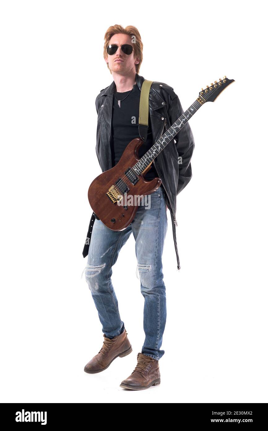 Cool attitude young handsome rock music guitarist with hands on back ...