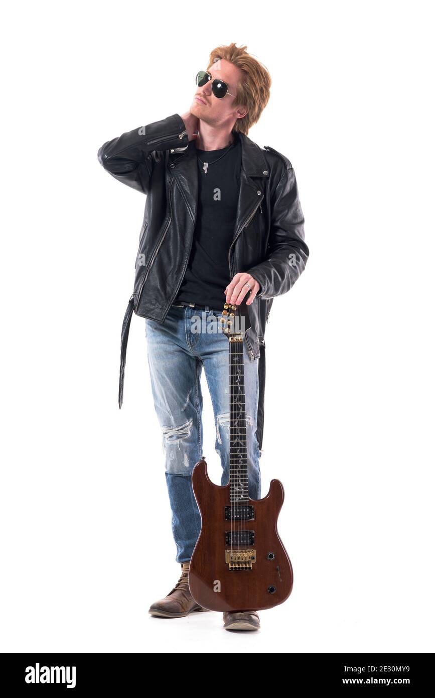 Macho fashionable young redhead rock musician posing with guitar with ...
