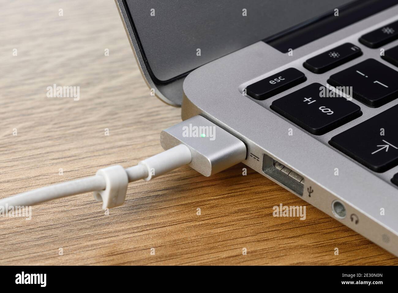 The Magsafe magnetically attached power connector on a 2012 Apple ...