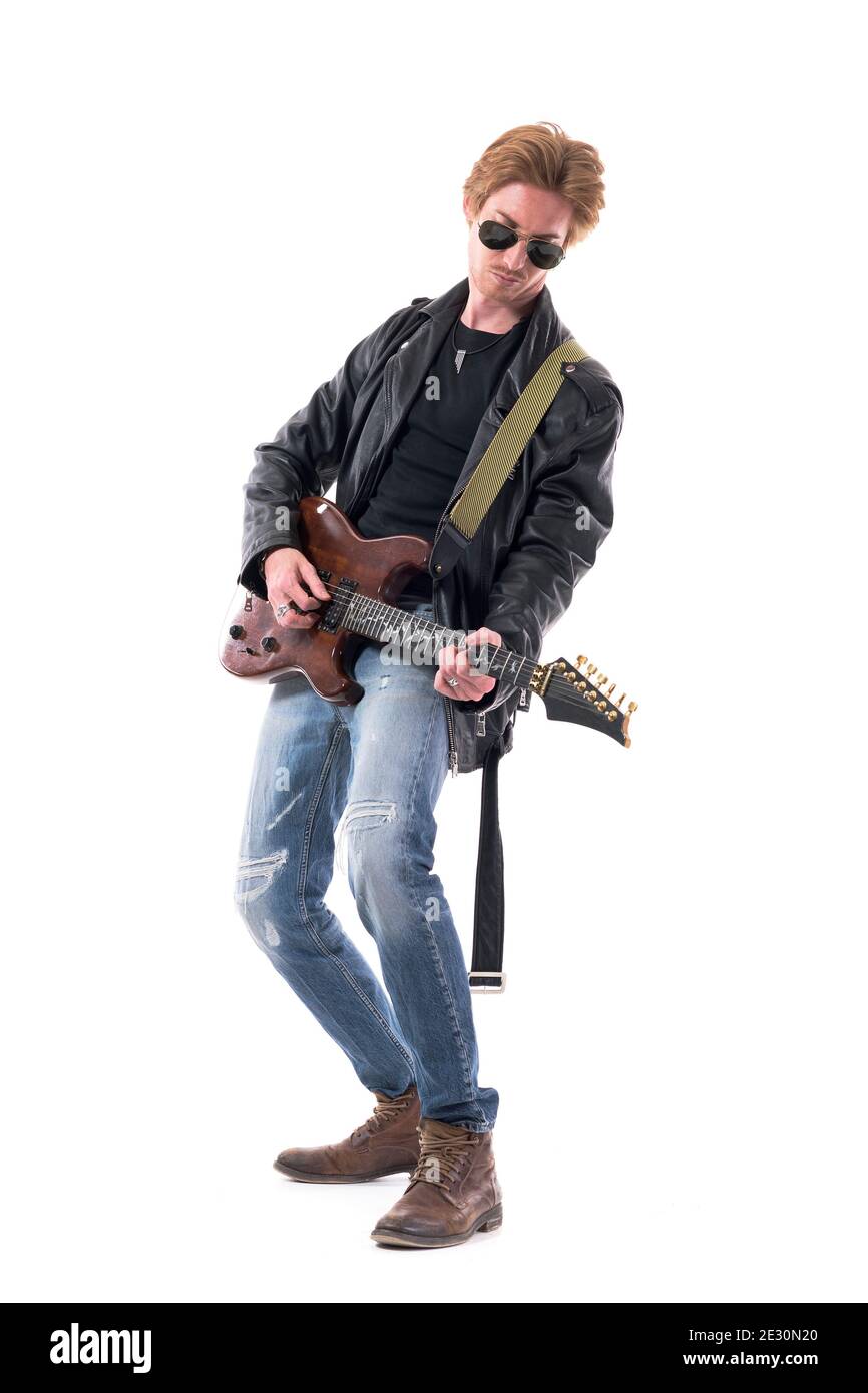 Handsome redhead man rock musician playing electric guitar with passion ...