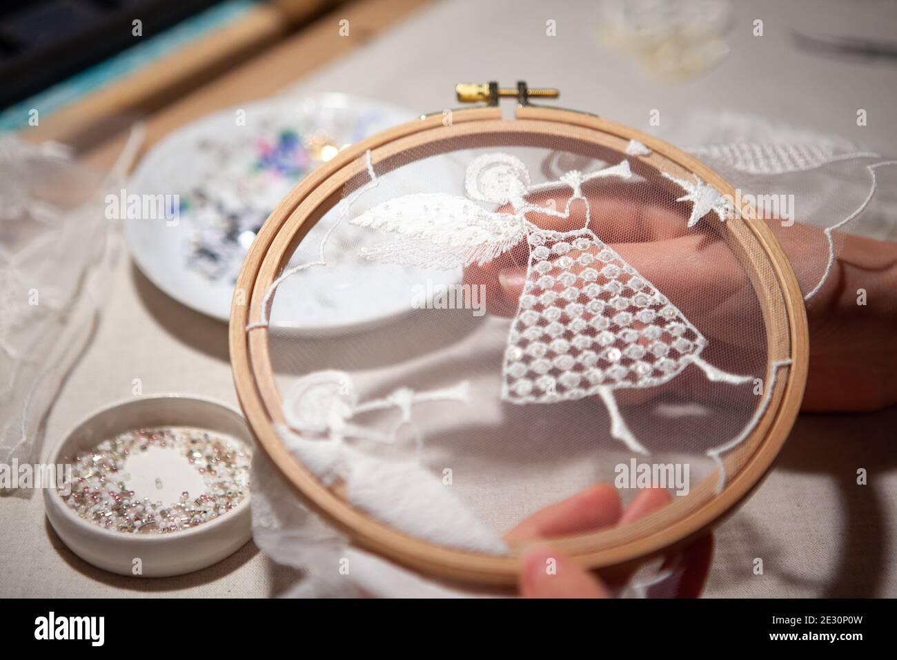 Workplace of an embroiderer with embroidery frames, angel embroidery ...