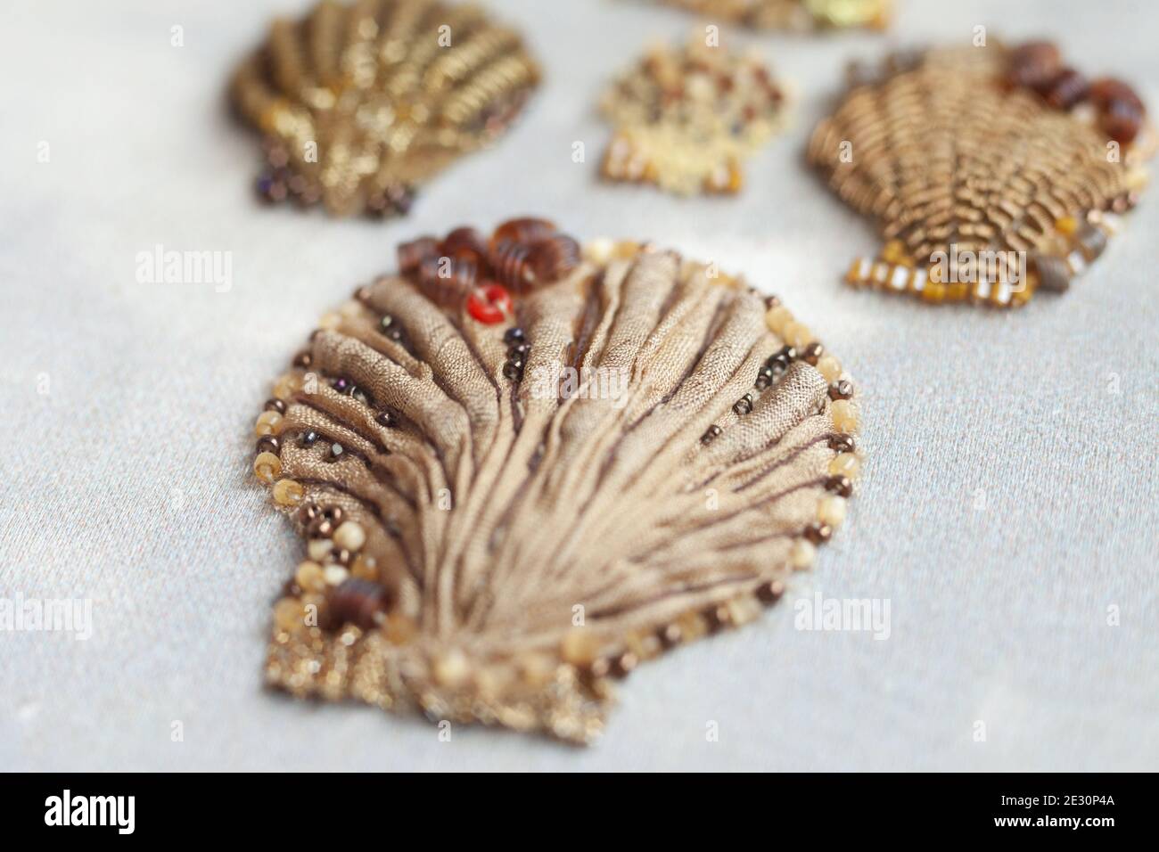 Couture embroidery of sea shells Stock Photo - Alamy