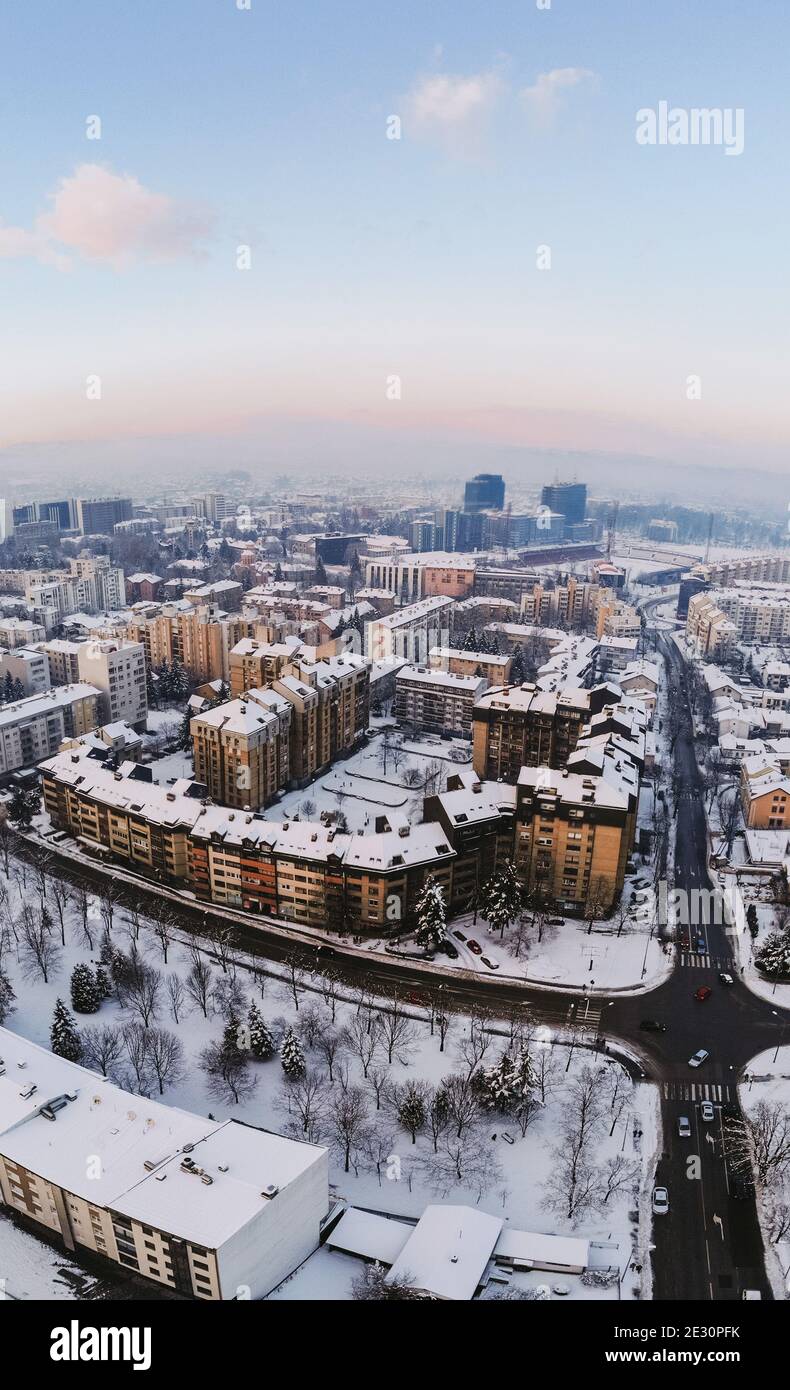 Vertical aerial view of an urban town with snow-covered traditional ...