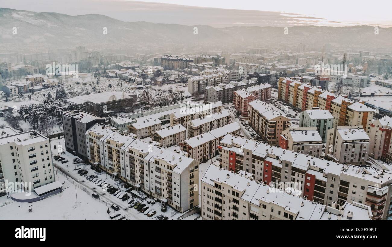 Aerial view of an urban cityscape of snow-covered typical residential ...