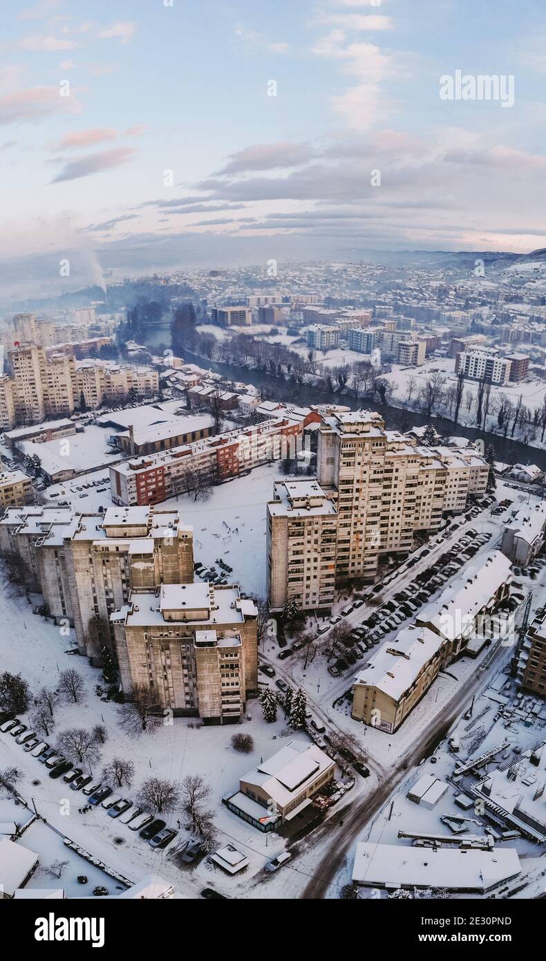 Aerial view of an urban cityscape of snow-covered traditional housing ...