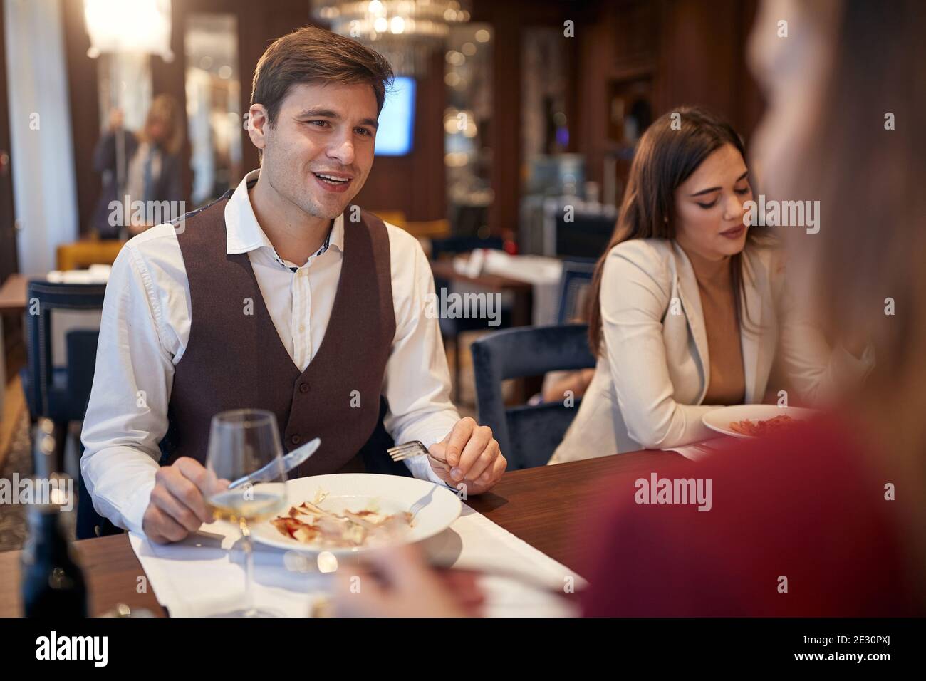 Young people enjoying eating lunch in a relaxed atmosphere at the ...