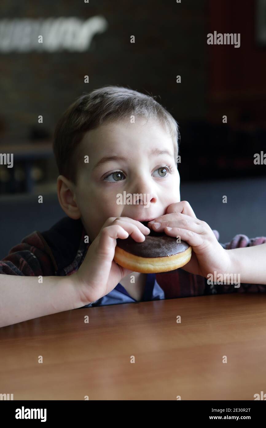 Fat boy eating chocolate hi-res stock photography and images - Alamy