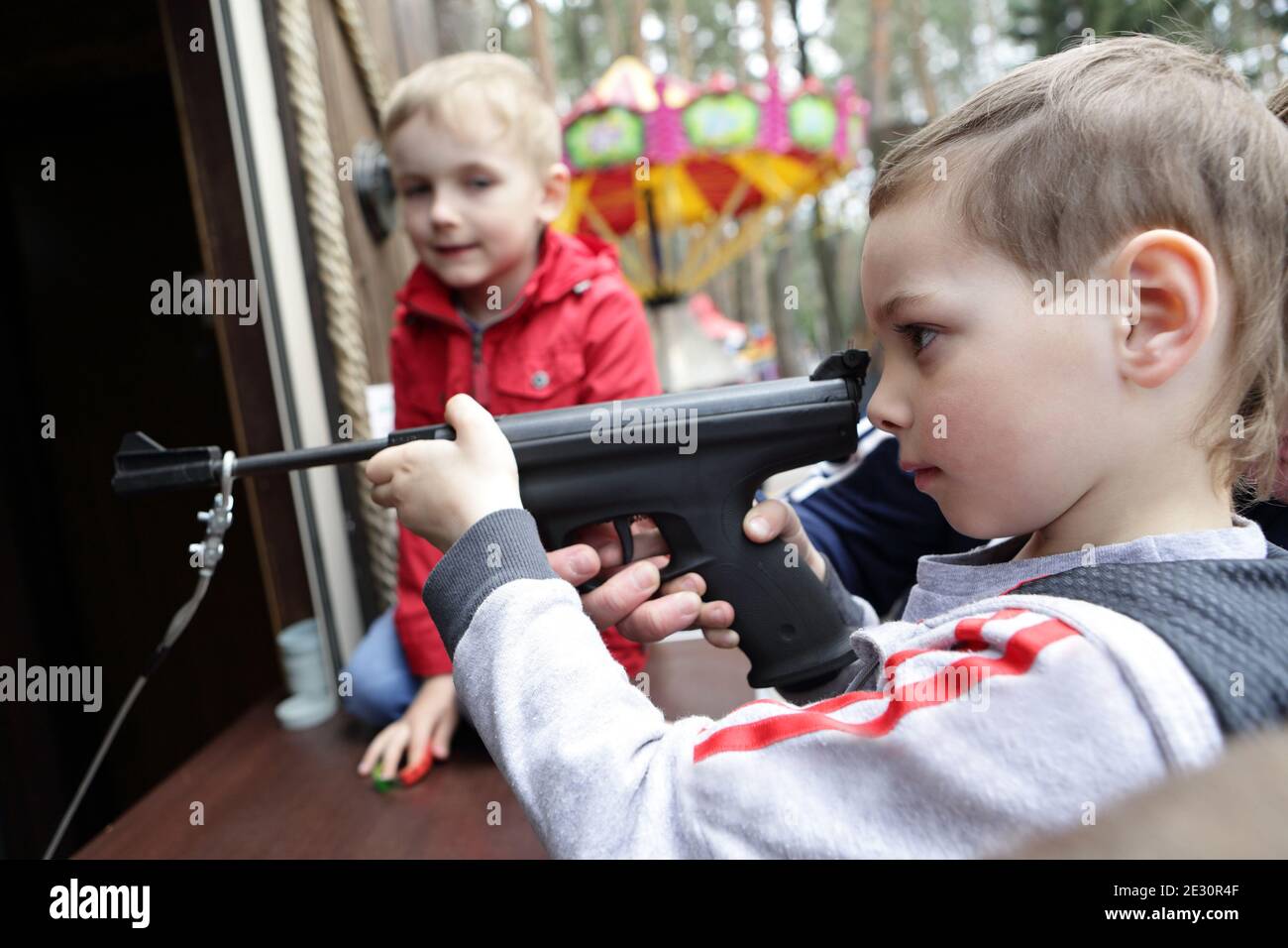 Kid shooting air pistol at the rifle range Stock Photo - Alamy